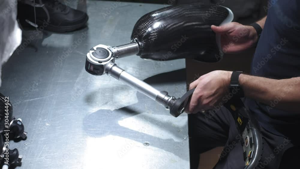 Production of a prosthetic leg. A man creates part of the leg. An ...