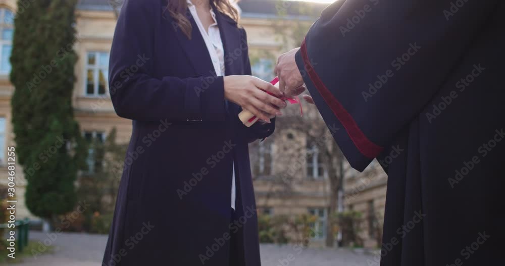 Young Caucasian beautiful woman professor handing diplomas and ...