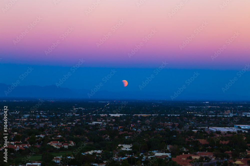 Beautiful gradient sky, partial lunar eclipse as backdrop. Phoenix ...