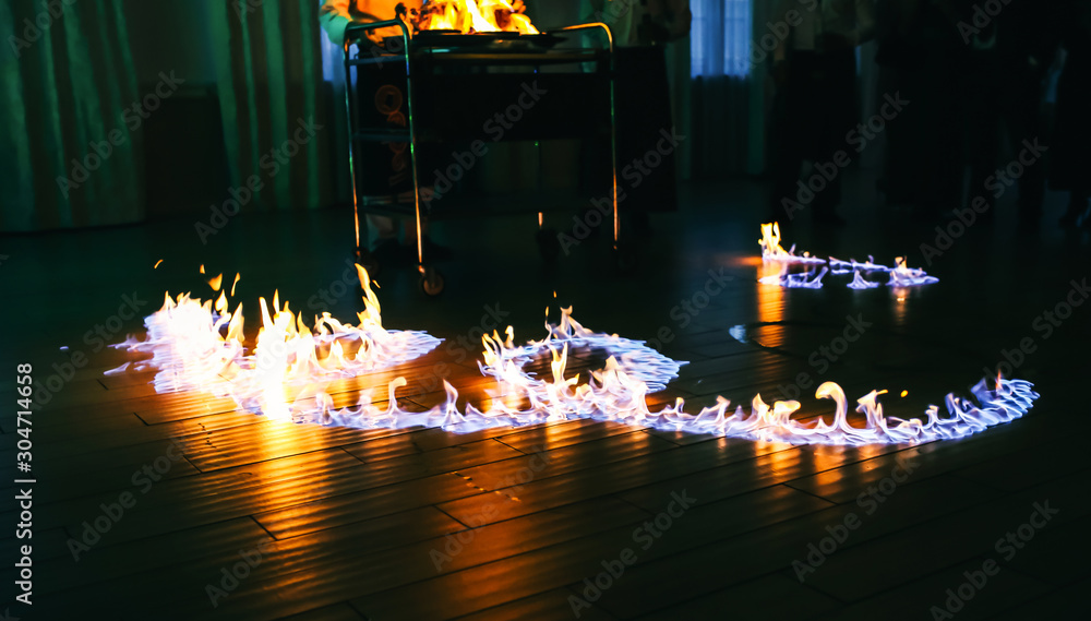 Fire presentation from a chef at the restaurant at wedding reception ...