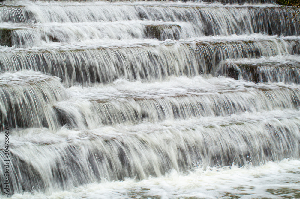Water Cascading over Weir Steps on canal slipway showing blur blurred ...