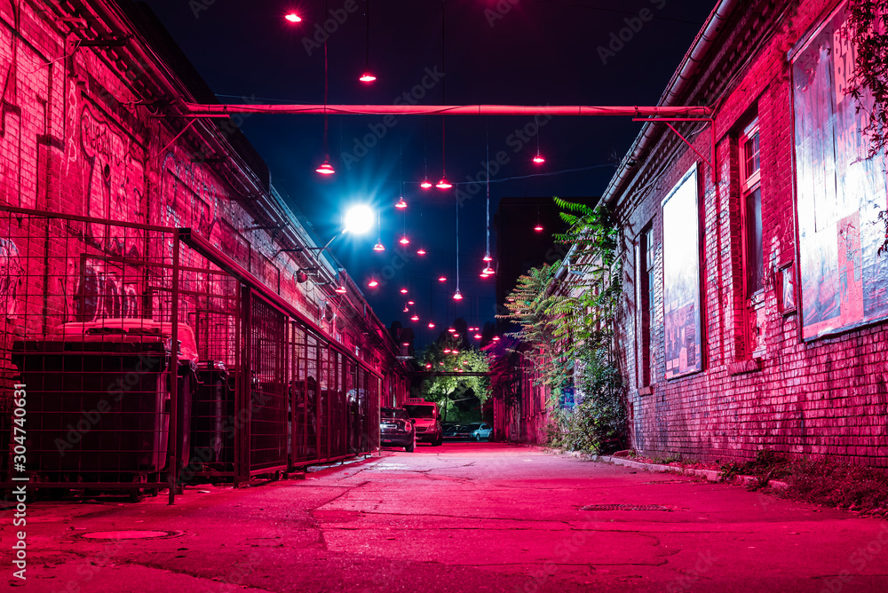 Red illuminated side street in a city, red illuminated backyard at ...