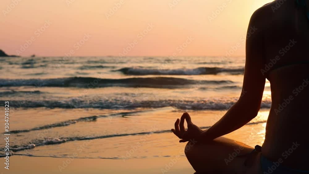yoga and relaxation on the beach, meditation, unrecognizable person ...