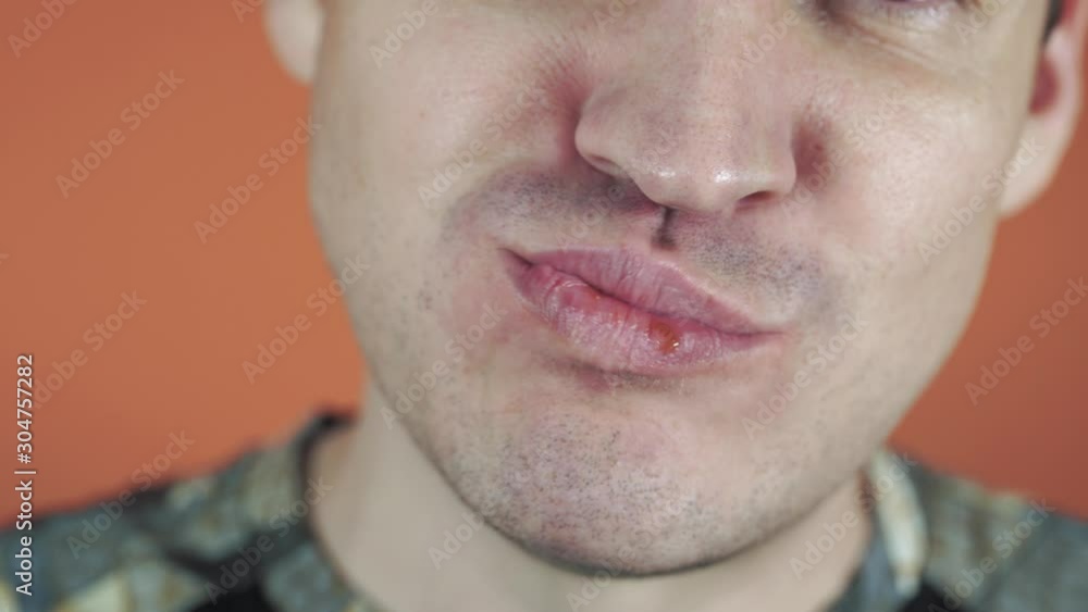 A portrait of the male body part on an orange background. A young man ...