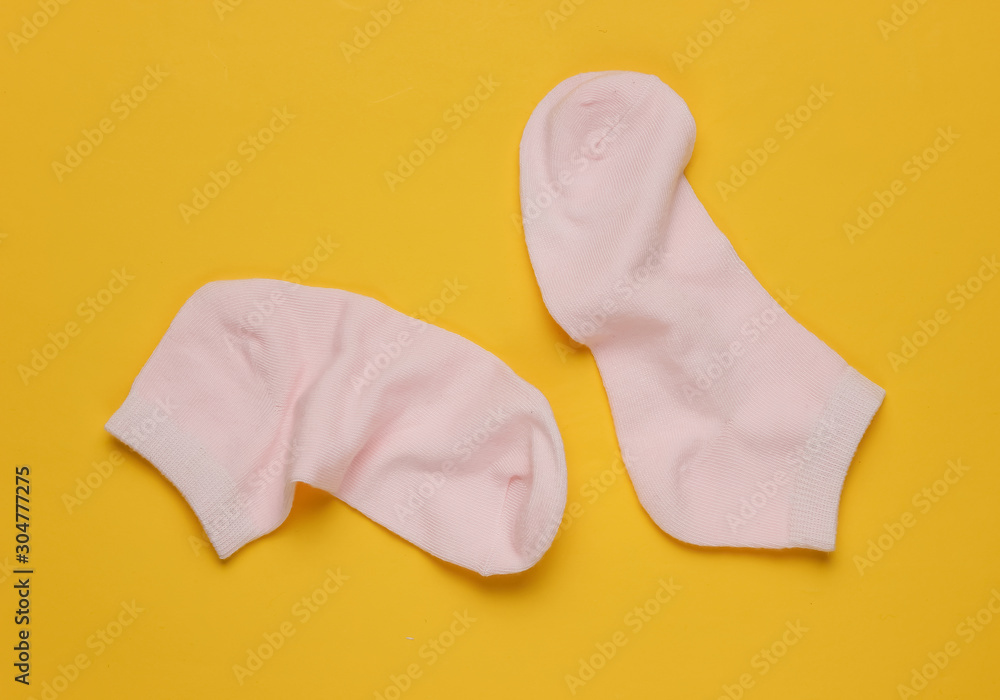 Pink socks on yellow background. Minimalism fashion concept. Pastel ...