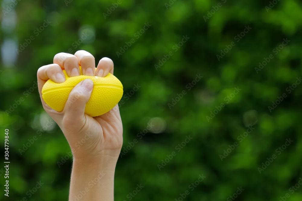 Hand holding stress ball and squeezing for relieve stress and ...