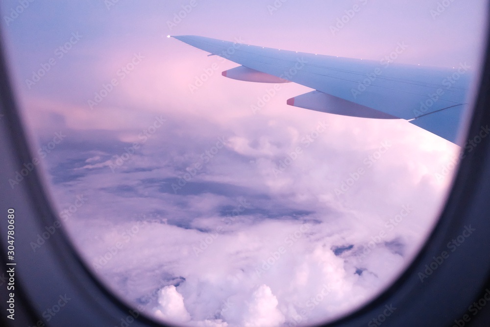 Top view white fluffy clouds with high sky and a plane wing,a view from ...