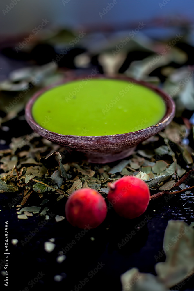 Close up shot of banyan tree paste in a clay bowl on black wooden ...