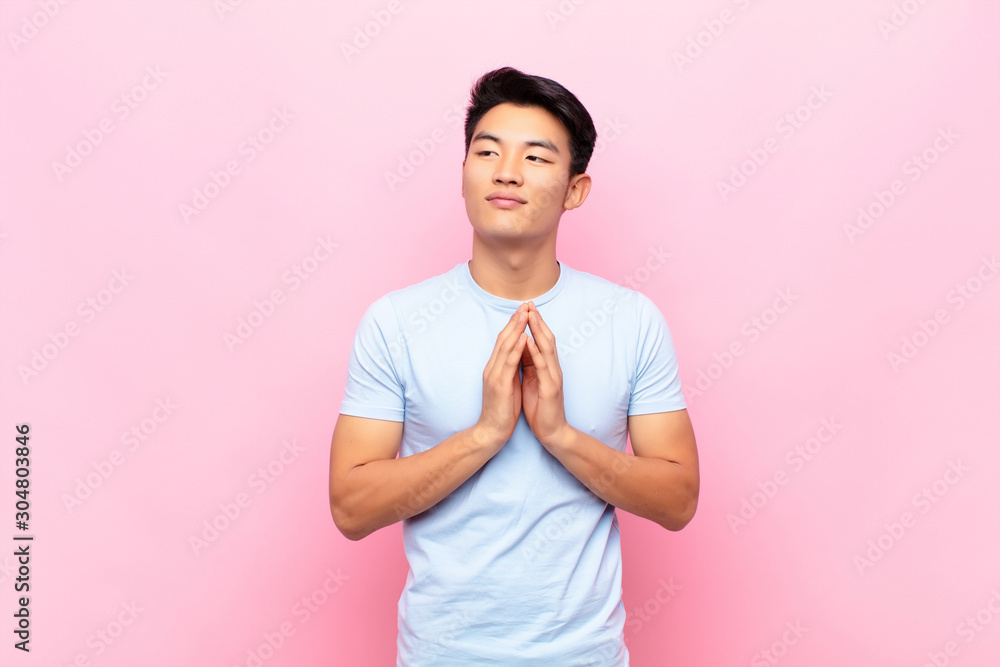 young chinese man feeling proud, mischievous and arrogant while ...