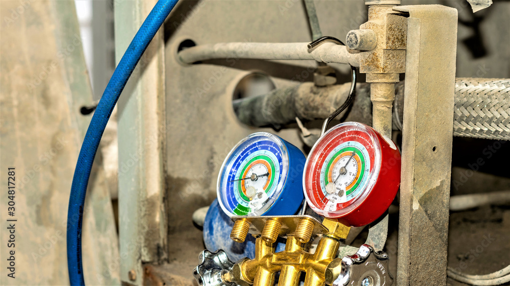 gas is being refiling into the heavy ac compressor of central air ...