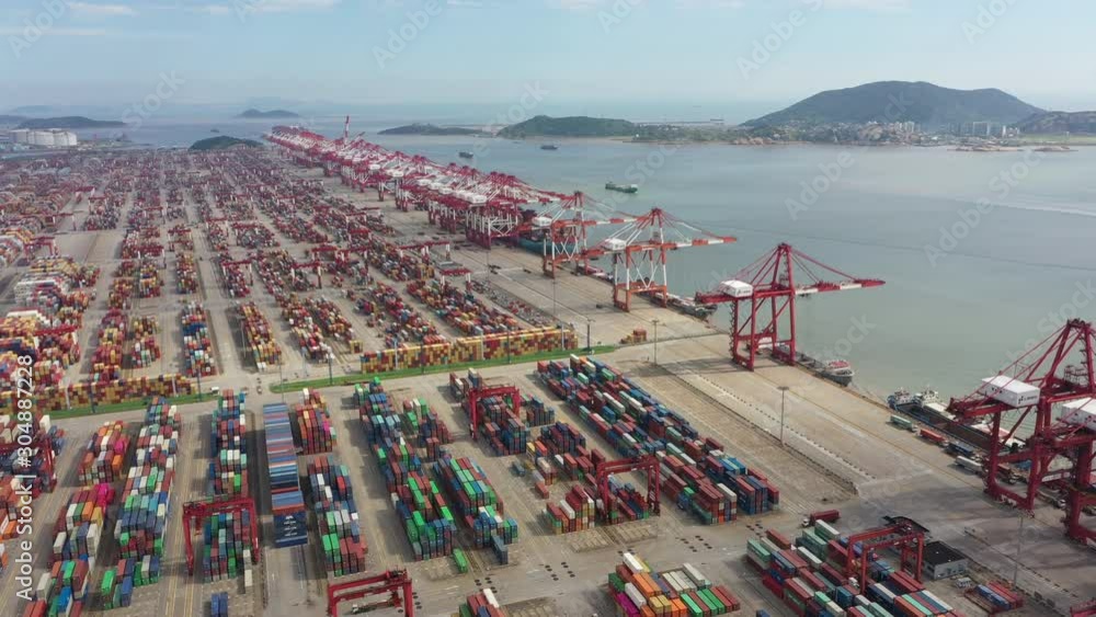 Retreating aerial view of massive container terminal in the deep water ...