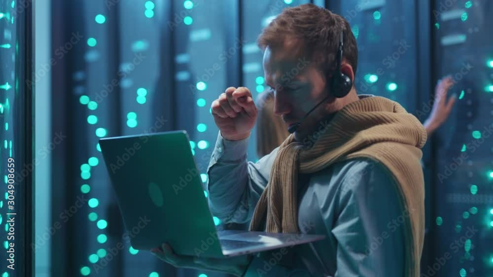 Tricky young man hacker typing on laptop computer making total power ...