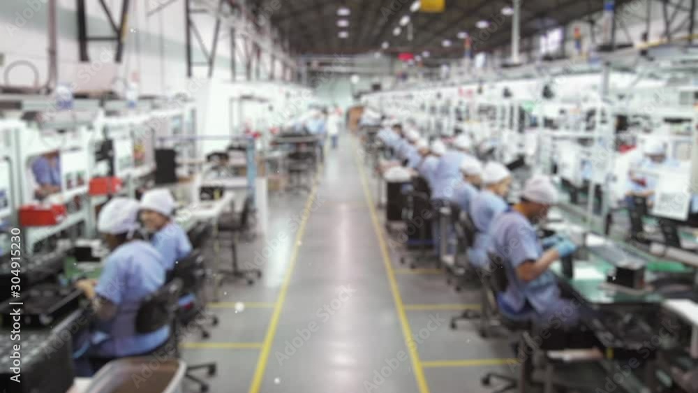 Blurred Workers at the Assembly Line of a Factory. Dust Particles ...