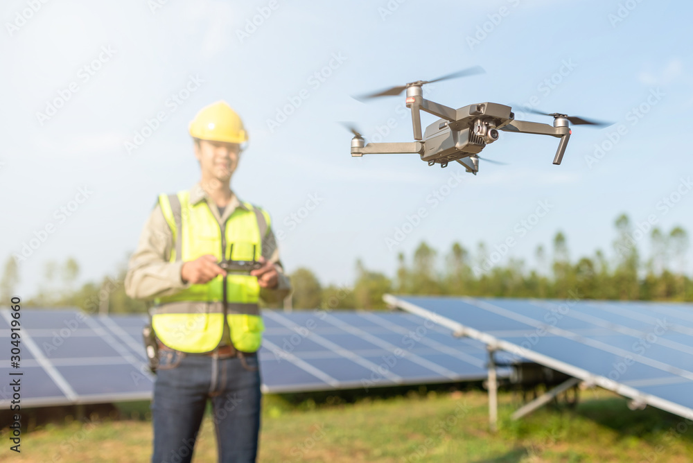 adult asian male engineer wearing safety vest using drone for survey ...