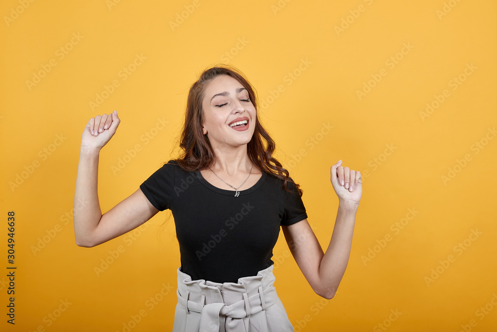 Beautiful girl in black is dancing around. She is happy and relaxed and ...