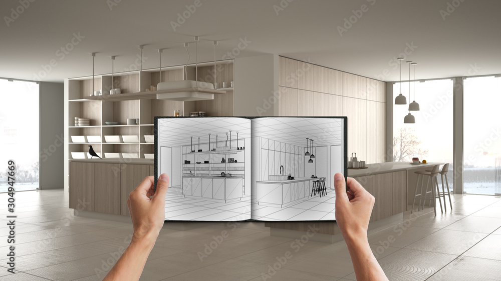 Hands holding notepad with creative kitchen design blueprint sketch or ...