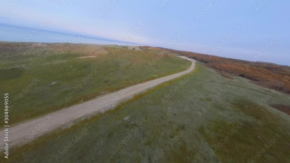 Fast drone shot starting above a World War Two bunker in the dunes of ...
