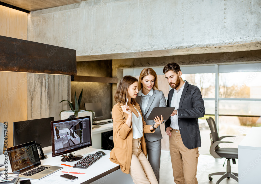 Small group of creative office employees working with digital tablet ...
