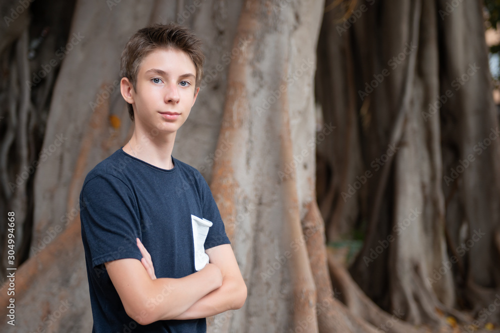 Handsome young boy at summer park. Beautiful calm smiling teen boy ...