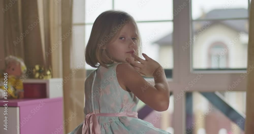 Back view close-up of Caucasian girl looking at camera over the ...