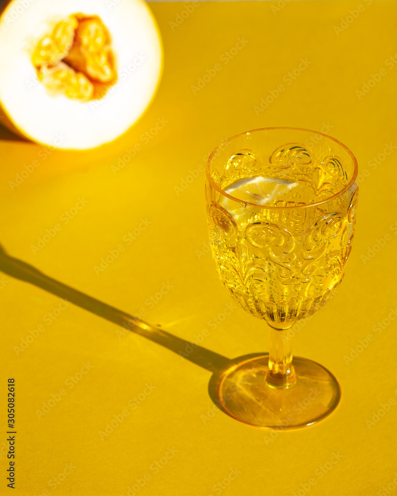 elegant yellow glass with drinking water, wine, tonic, champagne with a ...