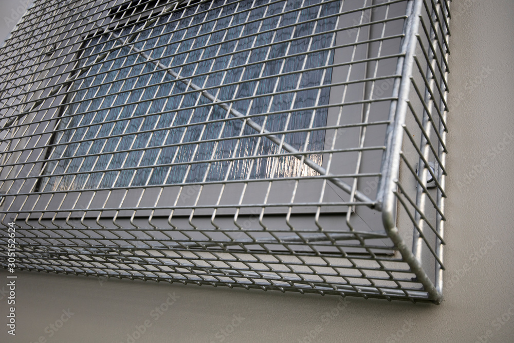 Window security wire mesh frame fixed externally to building wall to ...