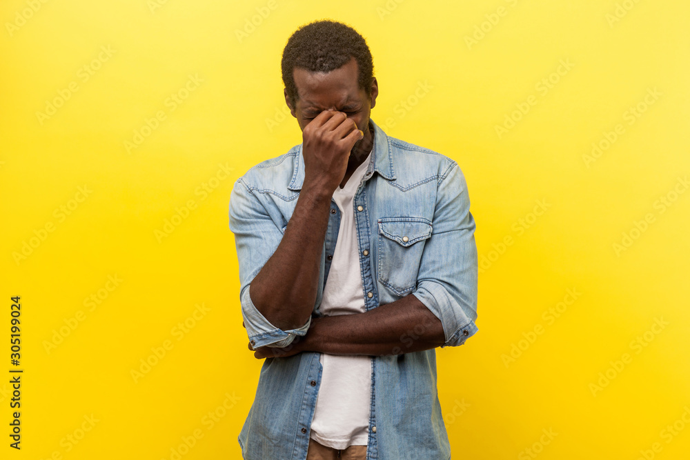 Portrait of depressed hopeless man in denim casual shirt with rolled up ...