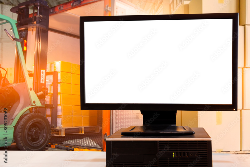 Computer blank screen on table with forklift loading cargo shipment ...