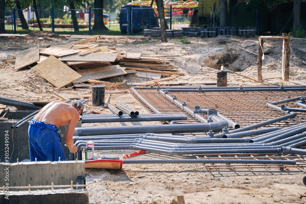 building a fountain. laying pipes in the foundation. Stock Photo ...