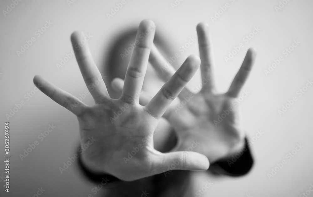 Little girl protects herself with hands, child's face out of focus ...