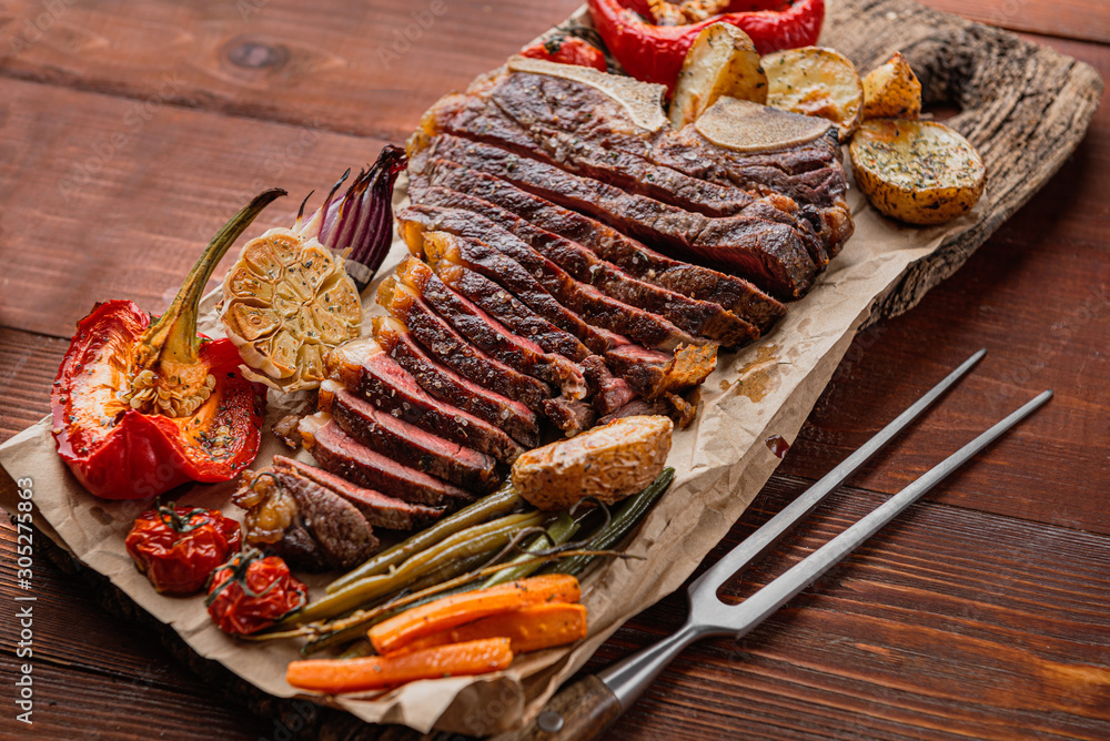 marbled beef steak on the bone cooked to a state of medium rare grill ...