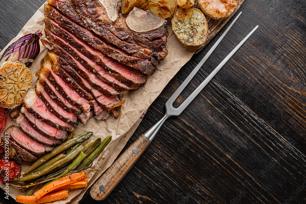 marbled beef steak on the bone cooked to a state of medium rare grill ...