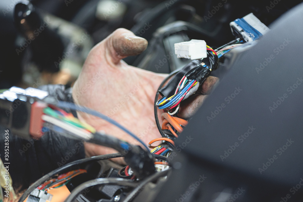 Auto electrician is working with car wiring close up. Stock Photo ...