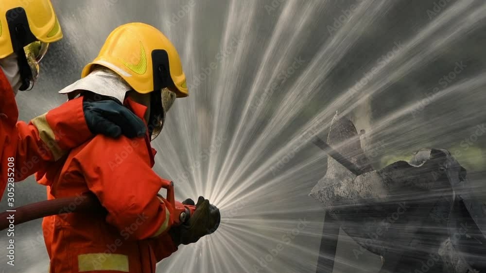 Firefighter on duty in Burning car. Three firefighters fighting a fire ...