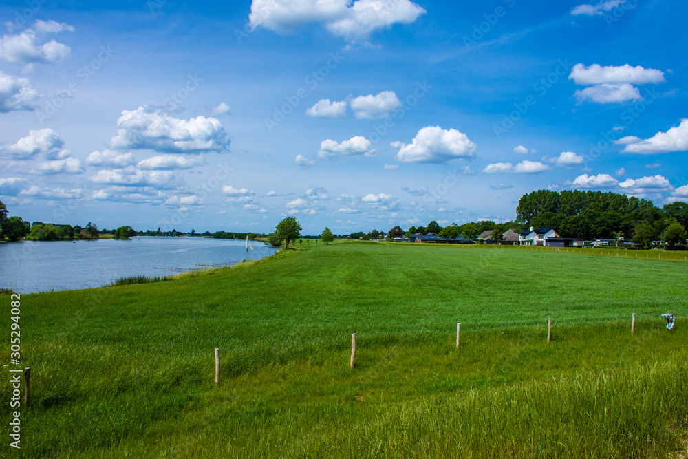 Dutch river landscape. Maas River in the Dutch village of Aijen in the ...