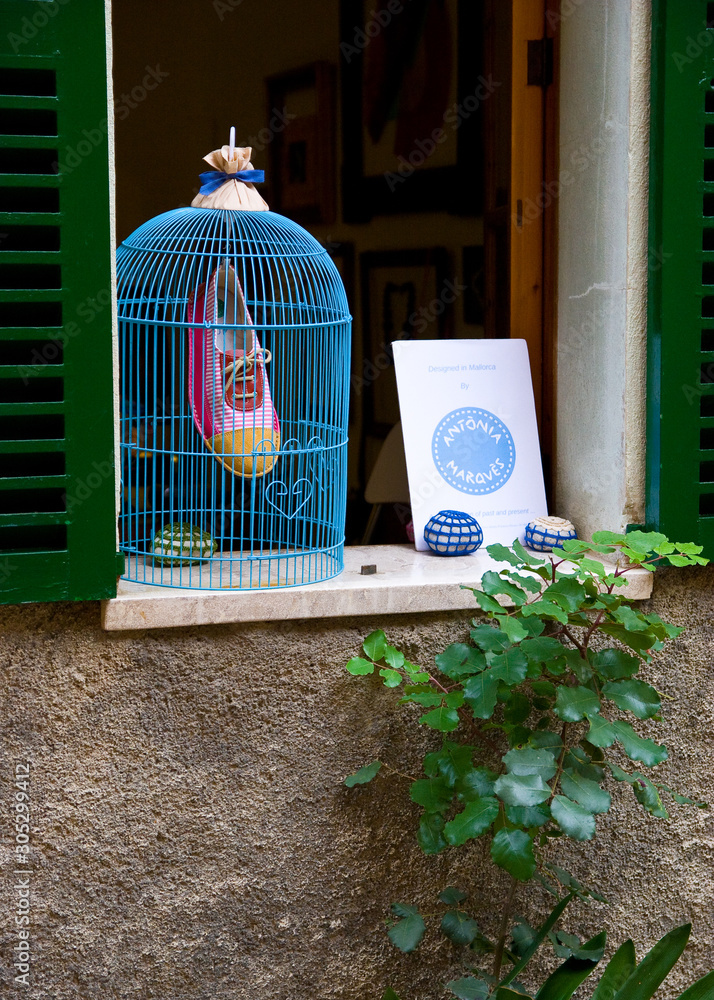 Blue bird cage decorated whit paintet shoe inside at rustic green ...
