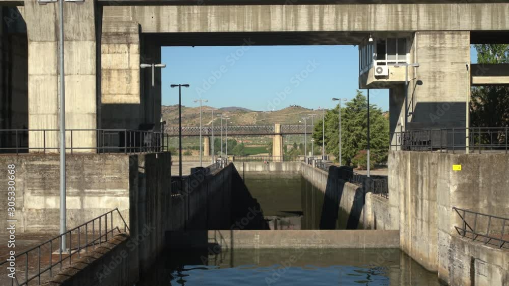 Closer view of Barragem do Pocinho dam as a river cruise boat on the ...