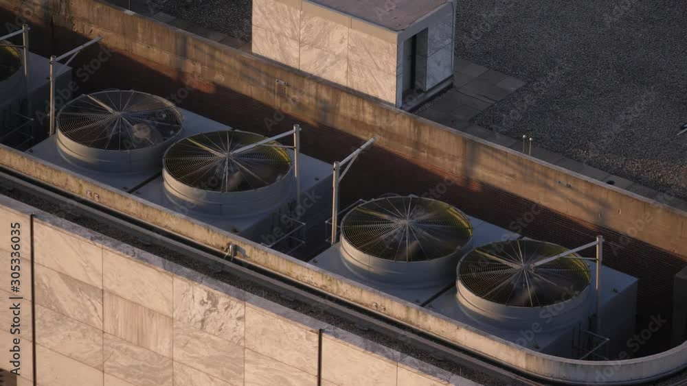 Close up panning aerial view looking down on large rooftop air ...
