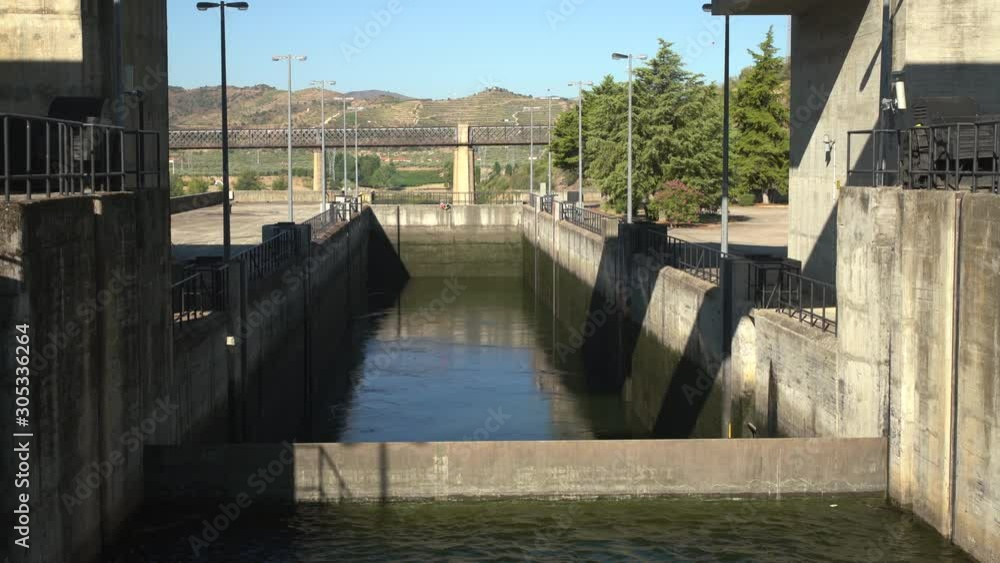 Closer view of Barragem do Pocinho dam as a river cruise boat on the ...