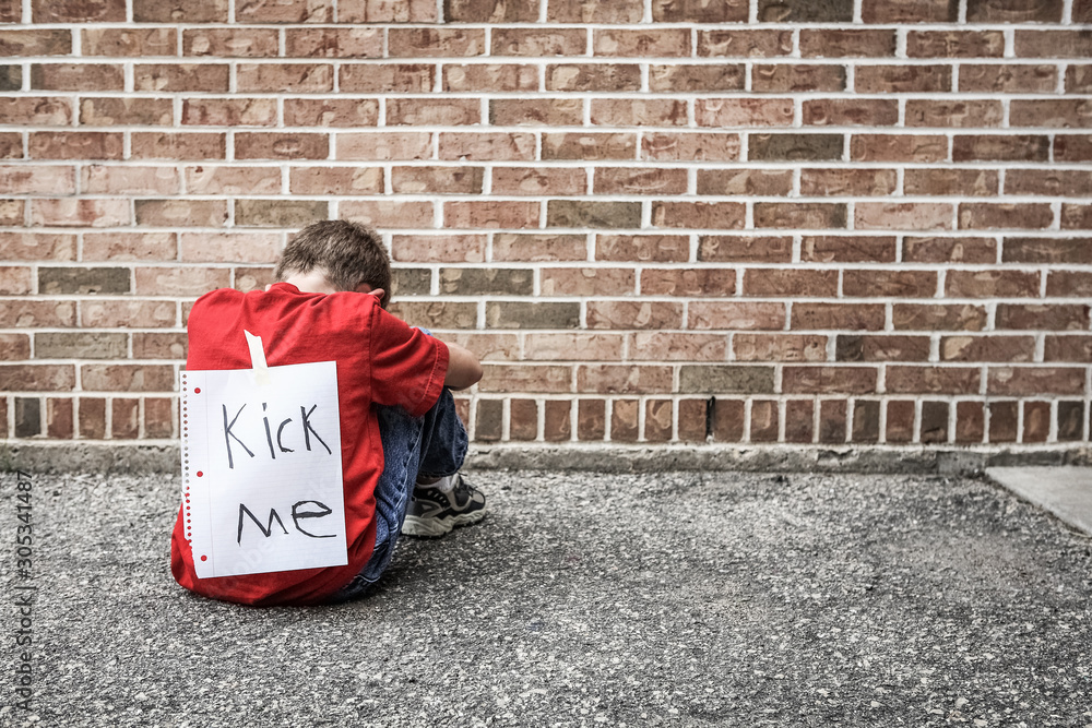 Sad boy with a kick me sign taped to his back, bullying concept Stock ...