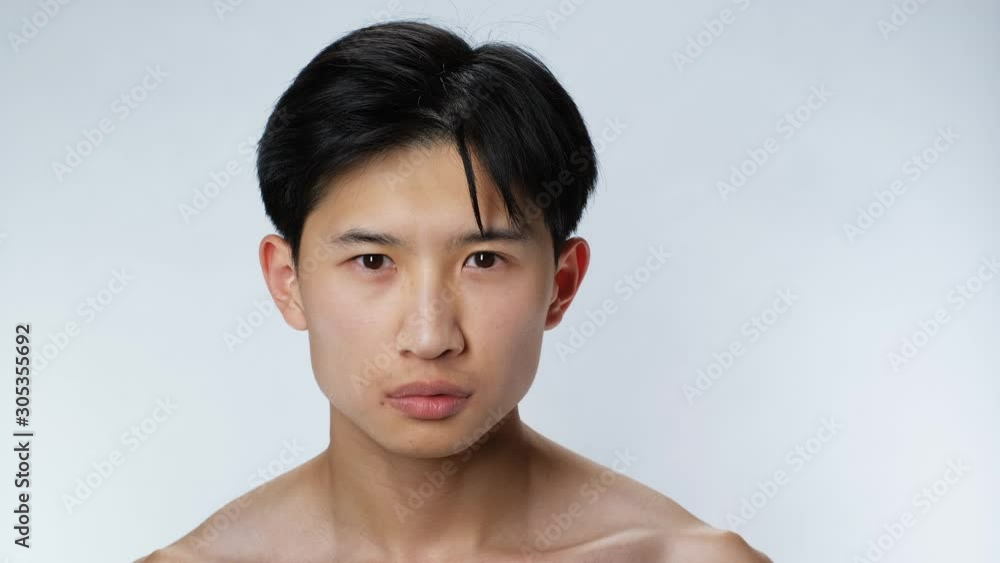 Asian face handsome man looking at camera confusion close up on white ...