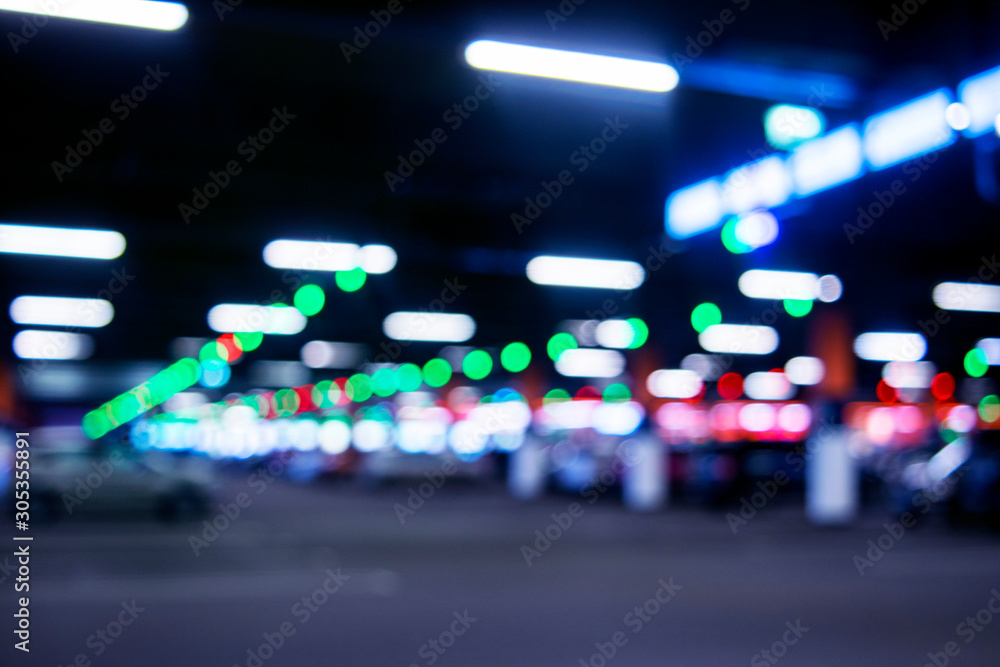 Blurred cars in car parking lot in shopping mall. Bokeh lights ...
