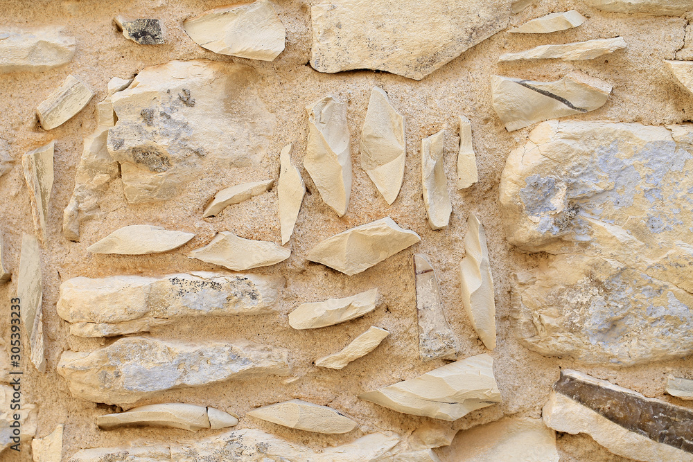 Background, old wall of stacked stone blocks with sharp edges of ...