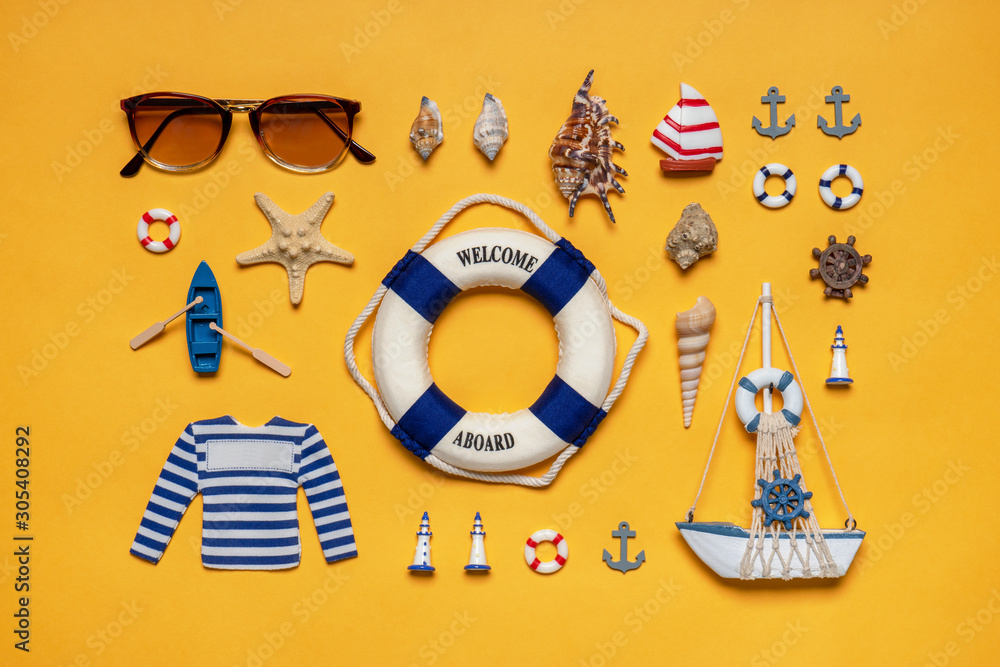 Various decorative nautical items, sailboat, life buoy and sunglasses ...