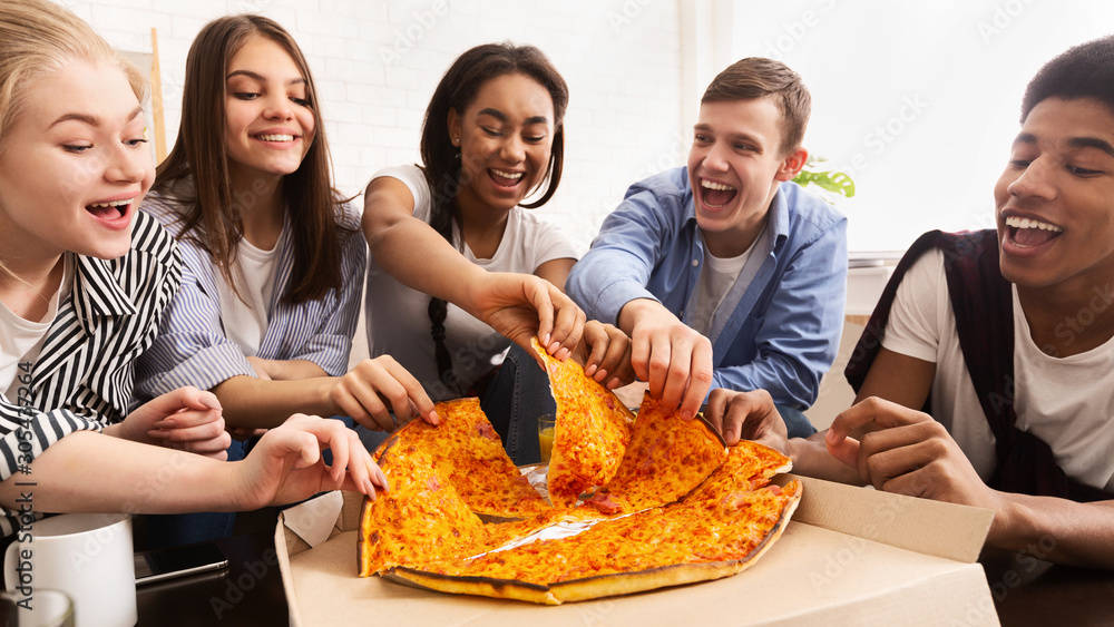 Pizza time. Teen friends sharing fast food together Stock Photo | Adobe ...