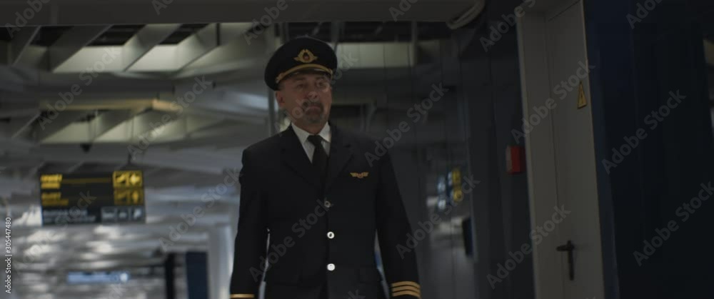 Vídeo do Stock: Capitan of aircraft in uniform suit and peaked cap goes ...