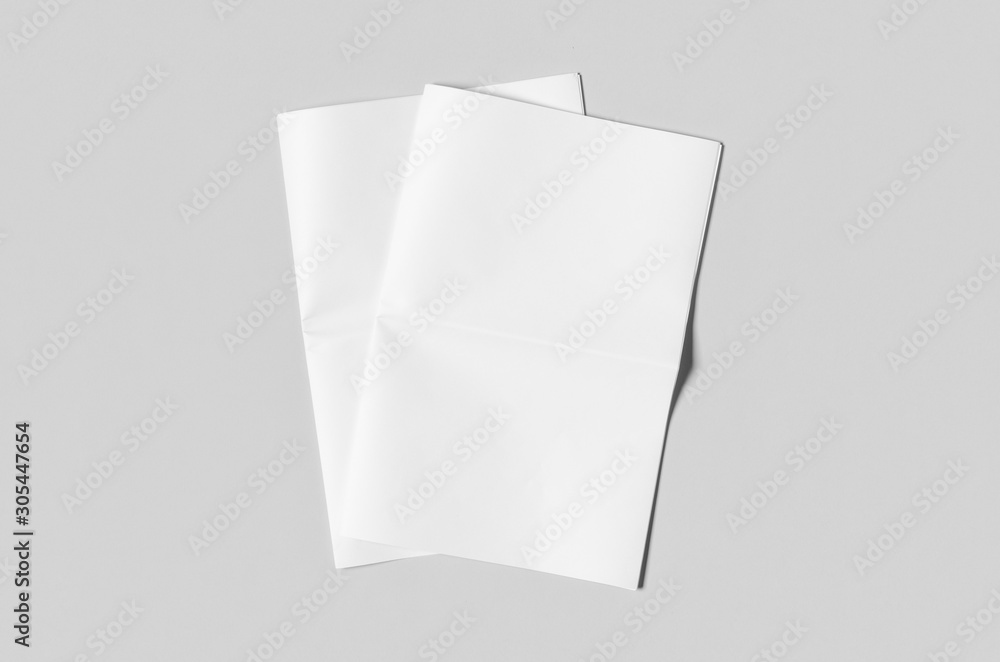 Blank newspaper mockup on a grey backgound. Stock Photo | Adobe Stock
