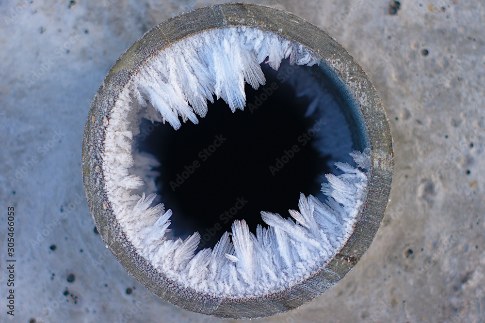 Water crystallization in the floor, ice inside the pipe section. Stock ...