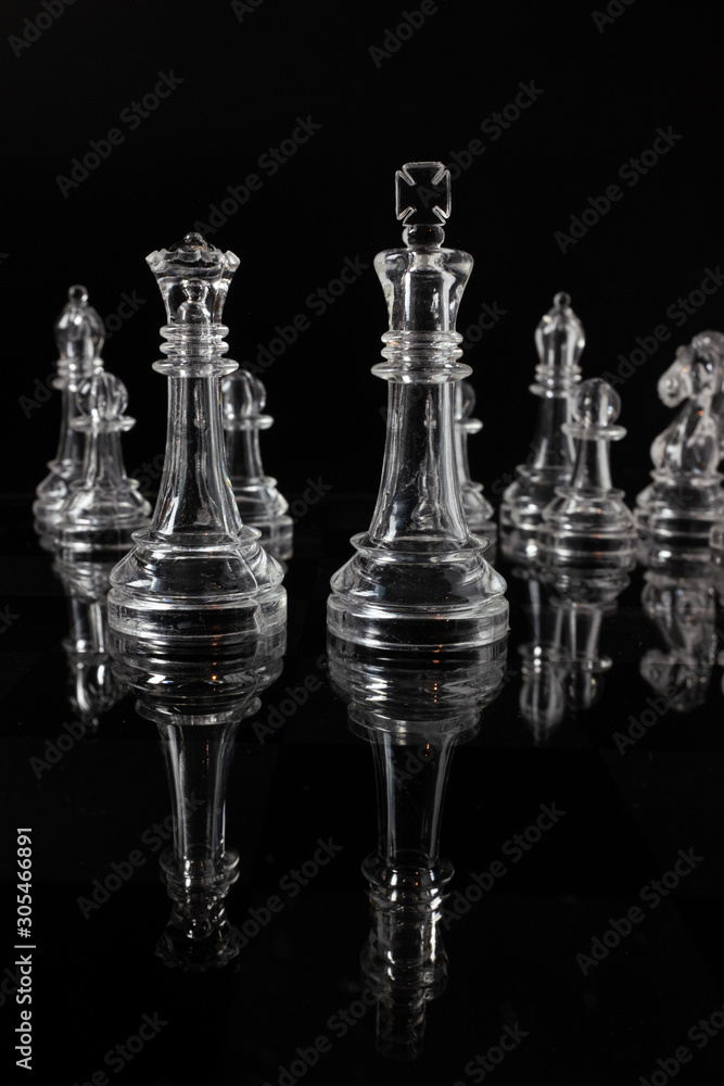 Transparent methacrylate chess pieces, front view placed on a black ...