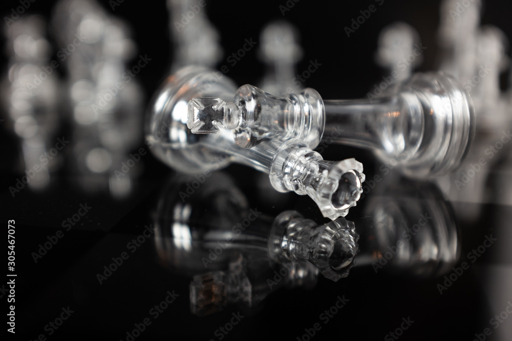 Fallen King and Queen Transparent methacrylate chess pieces on a black ...